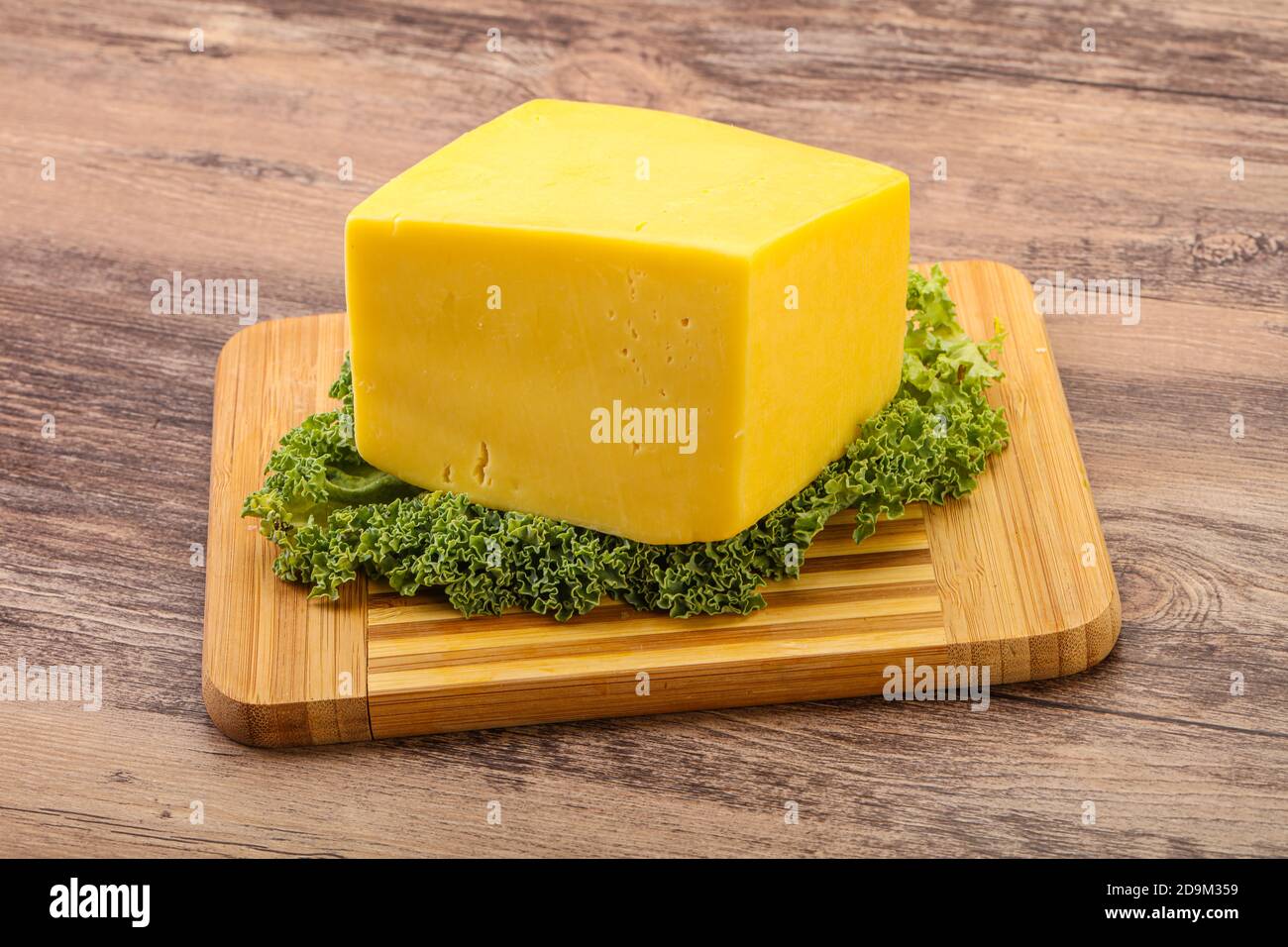 Yellow tilsiter cheese dairy product brick Stock Photo - Alamy