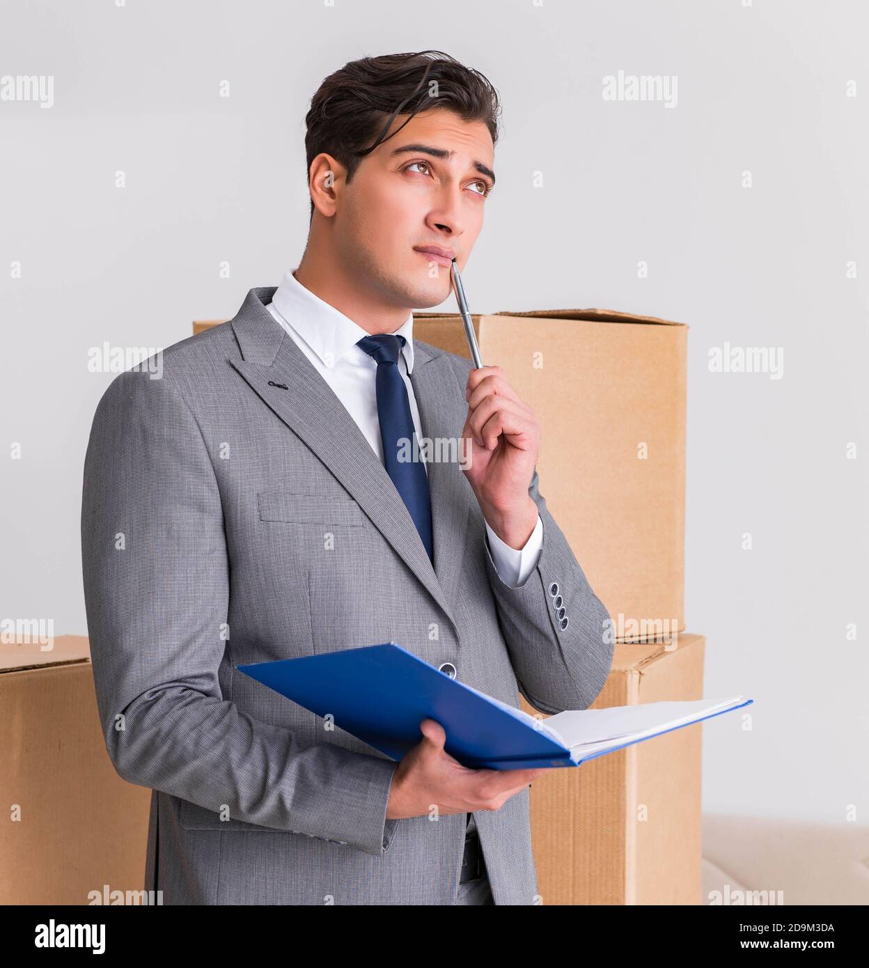 The man signing for the delivery of boxes Stock Photo - Alamy