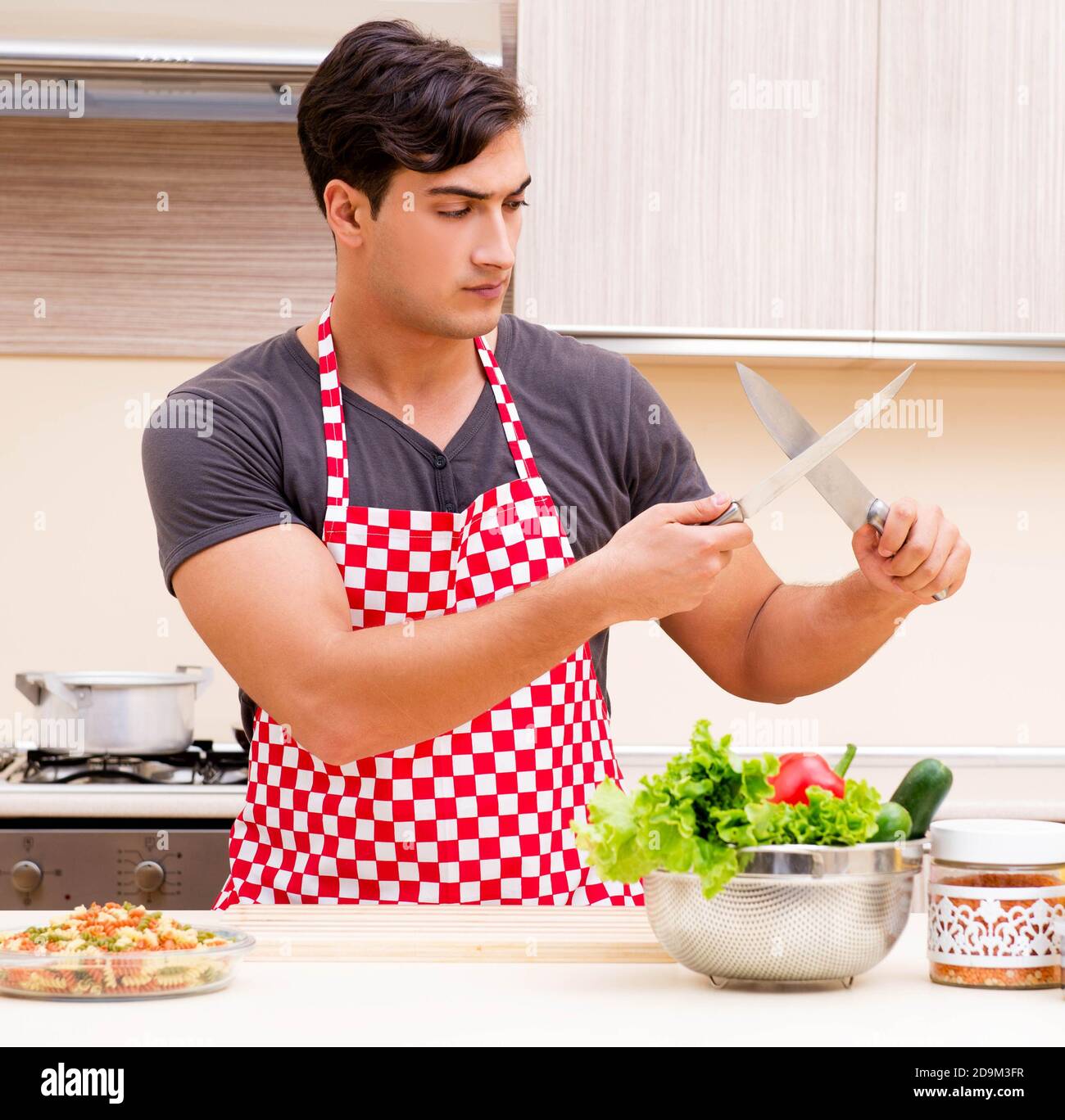 The man male cook preparing food in kitchen Stock Photo - Alamy