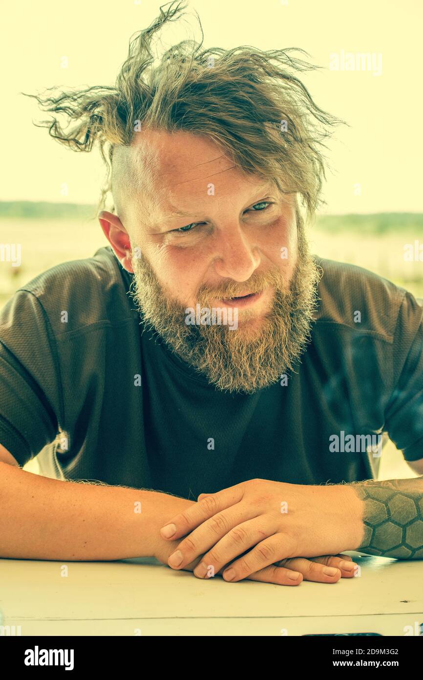Outdoor portrait of young handsome smiling ginger man with beard ...