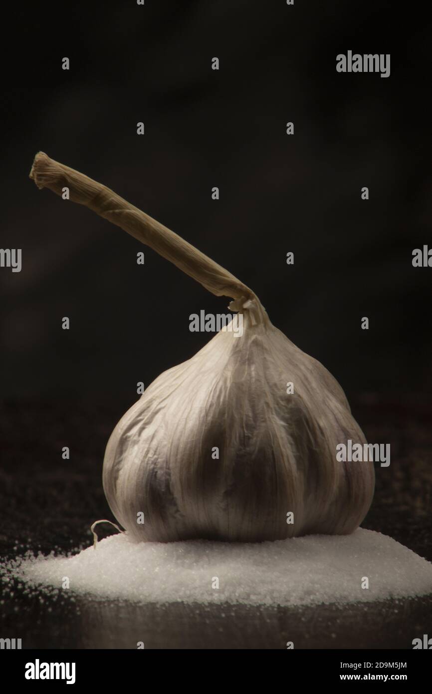 Vertical shot of a fresh head of garlic on black background Stock Photo ...