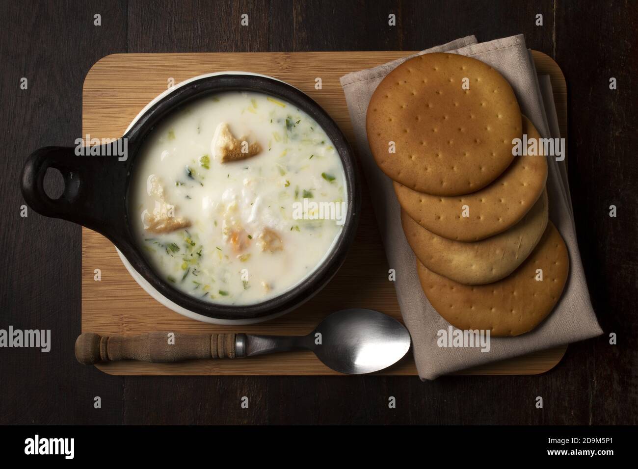 Top view of a traditional Colombian soup changua with round pieces of ...
