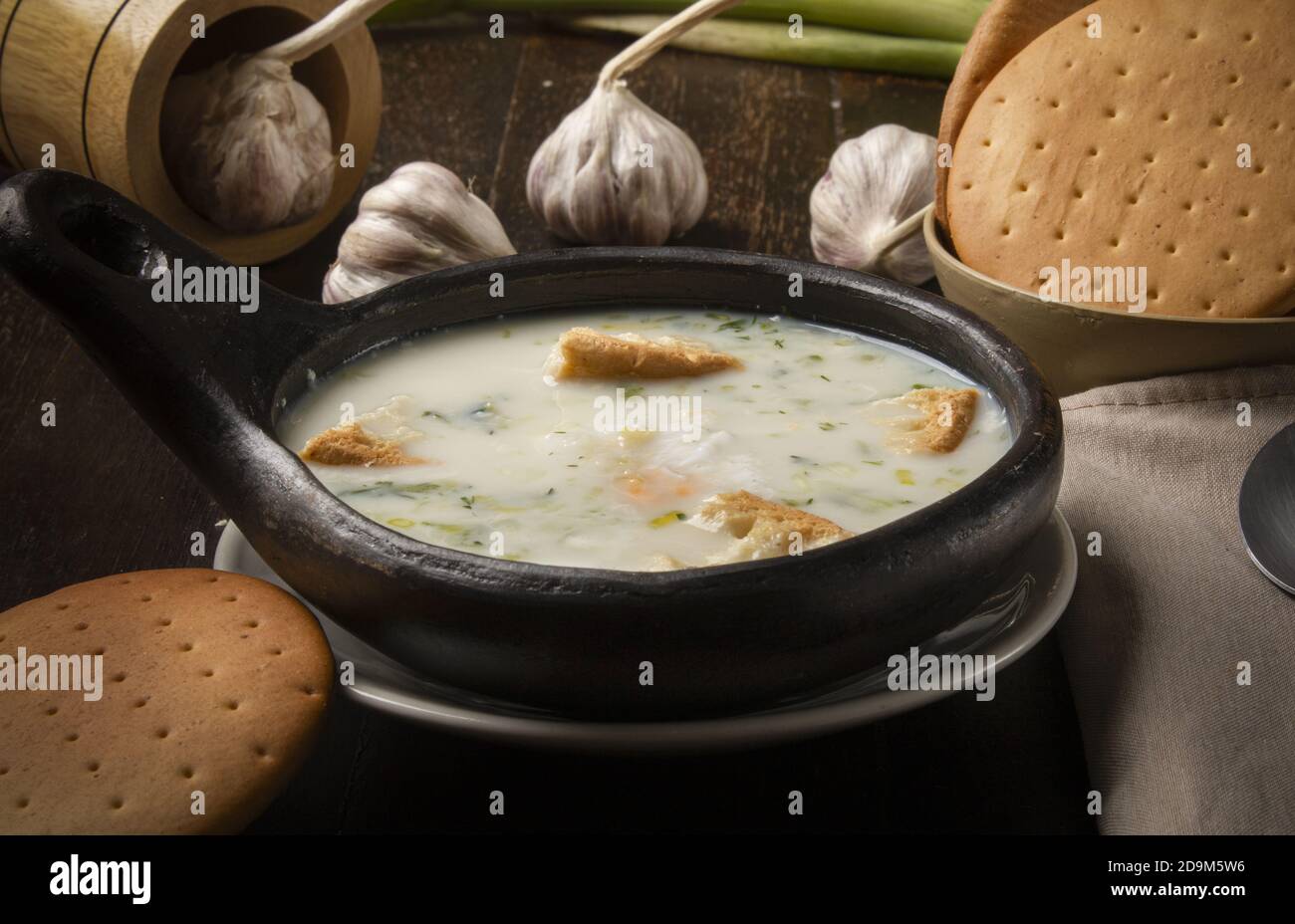 Traditional Colombian soup changua with round pieces of crunch biscuits ...