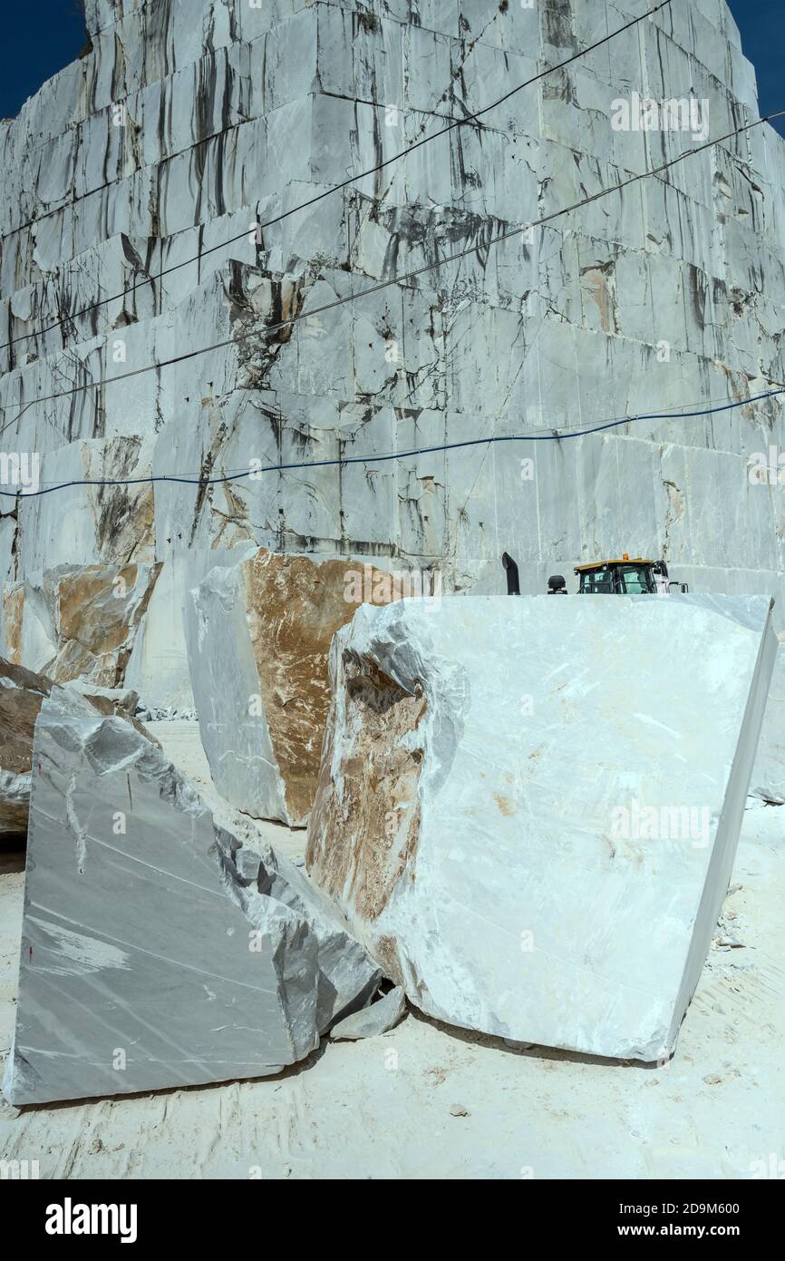broken blocks on white powder with vertical crag in background at ...