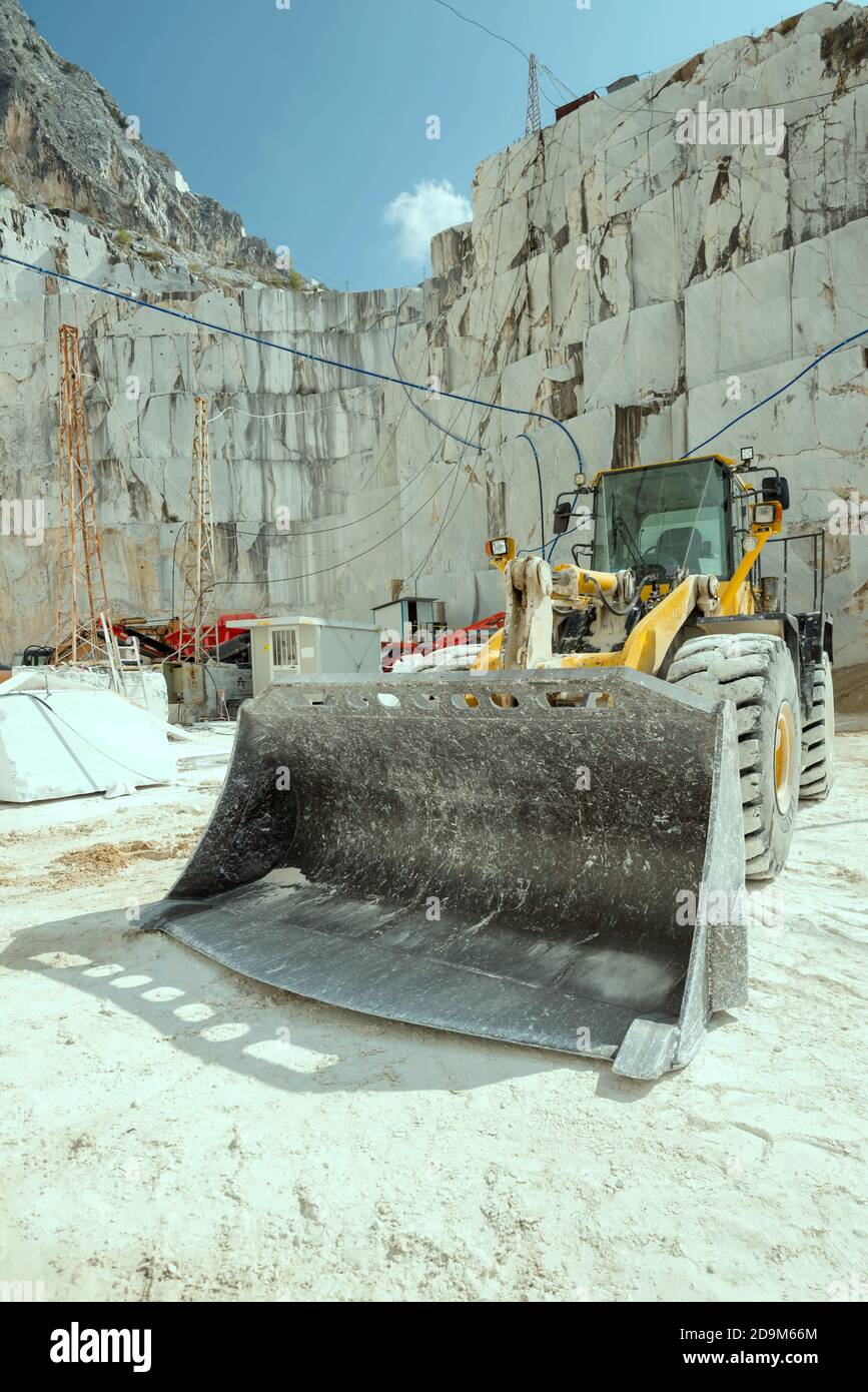 detgail of dozer big shovel on white marble powder at quarry, shot near ...