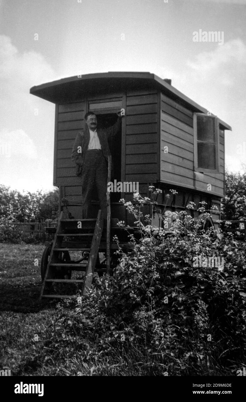 A smiling man stands at the entrance to his traditional shepherds hut ...
