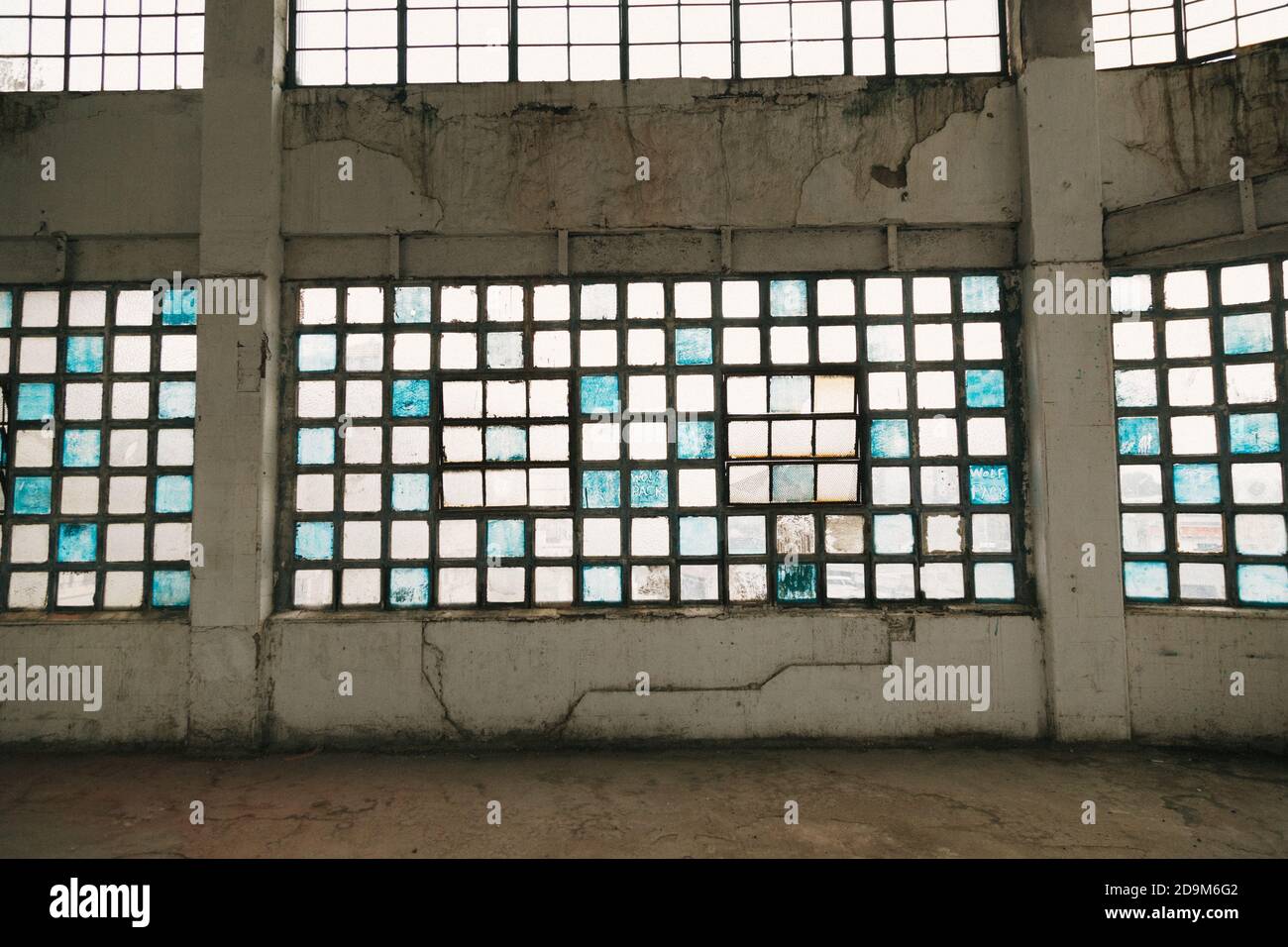 Blue and white square windows seen from inside an old abandoned ...