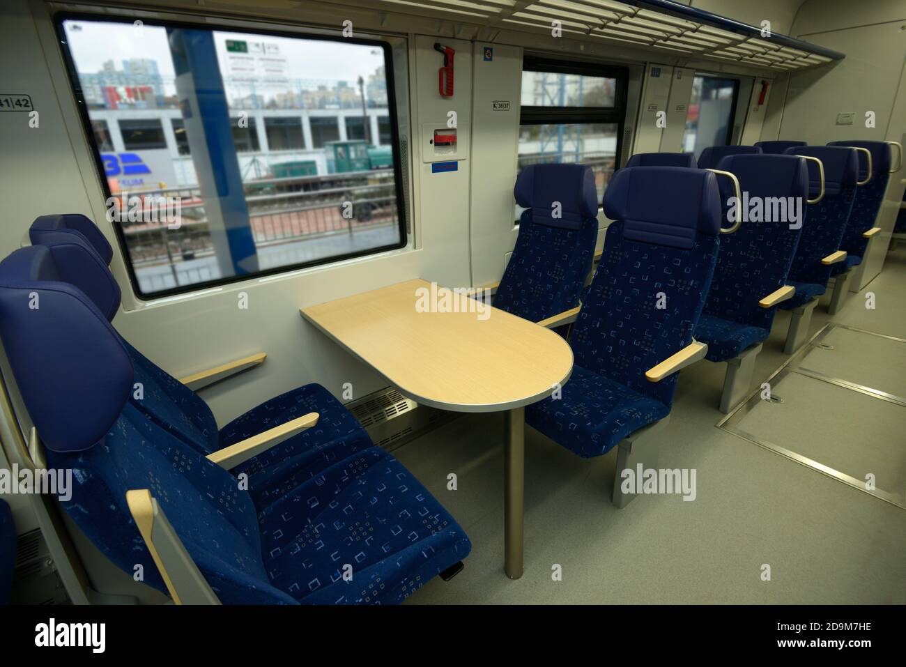 Empty 2 class compartment of wagon of commuter train, seats and doors ...