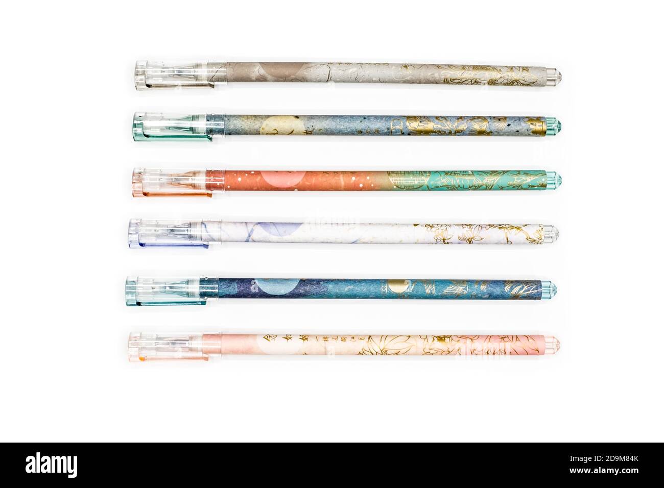 pens in various colors and patterns on a white background Stock Photo ...