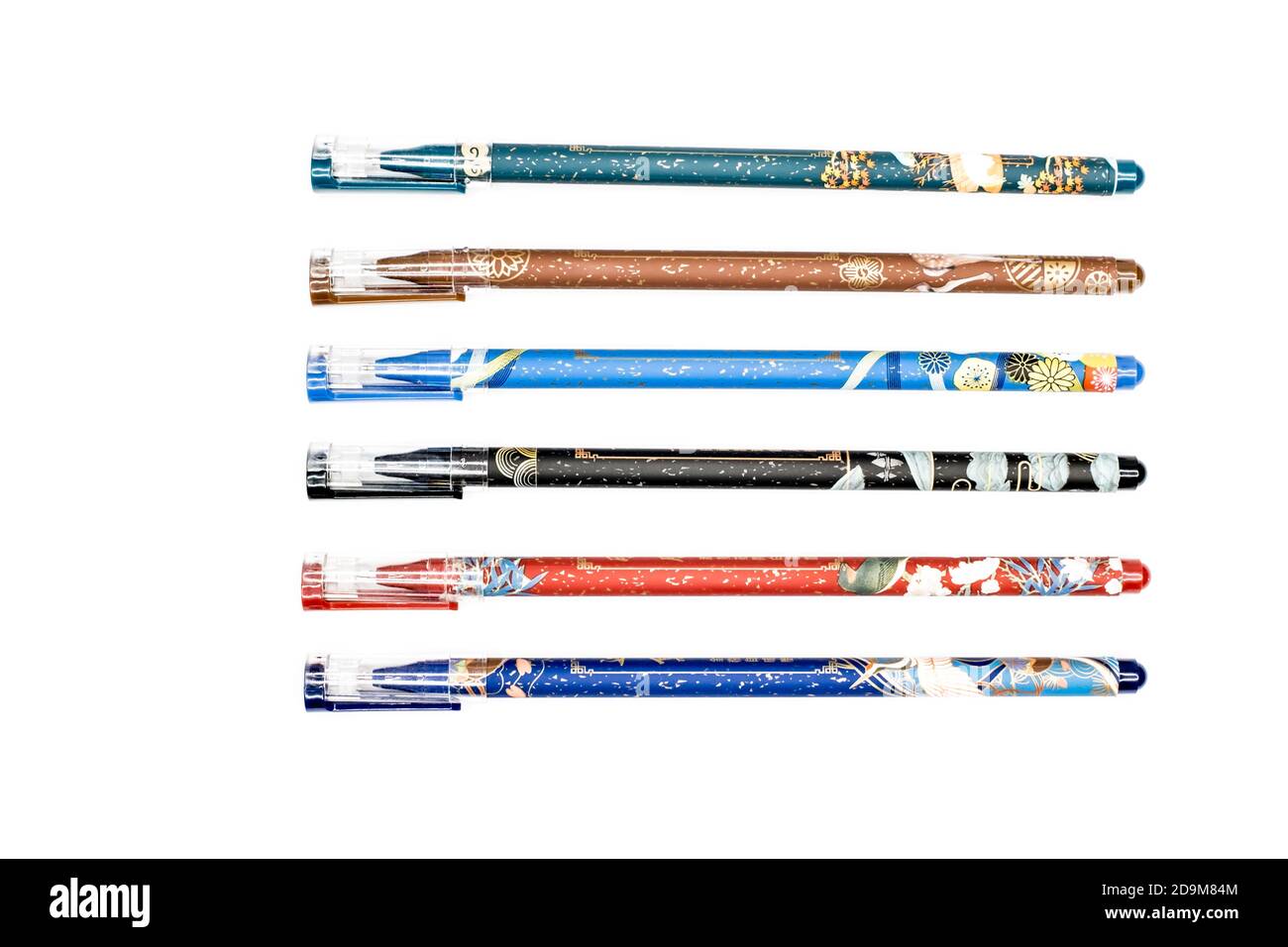pens in various colors and patterns on a white background Stock Photo ...