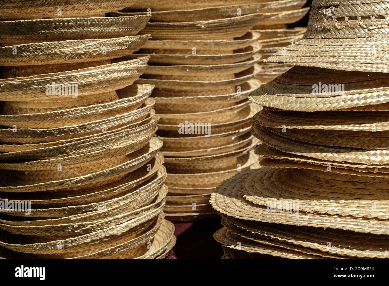 pile of straw hats on table Stock Photo - Alamy