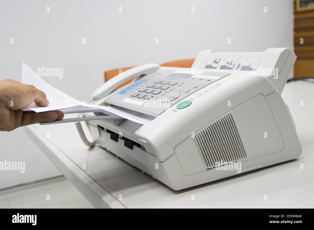 hand man are using a fax machine in the office, equipment for data ...