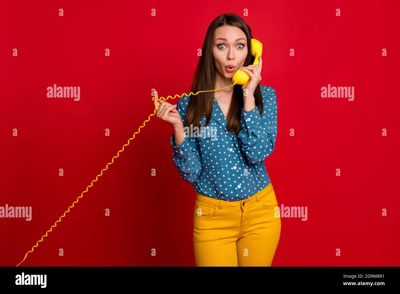 Portrait of attractive cheerful amazed girl talking best friend handset ...