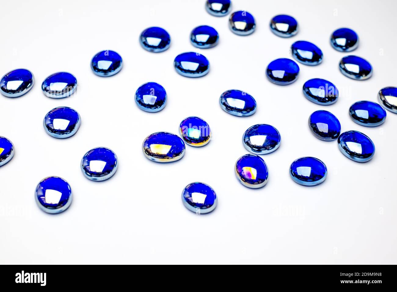 blue glass stones on a white background Stock Photo - Alamy