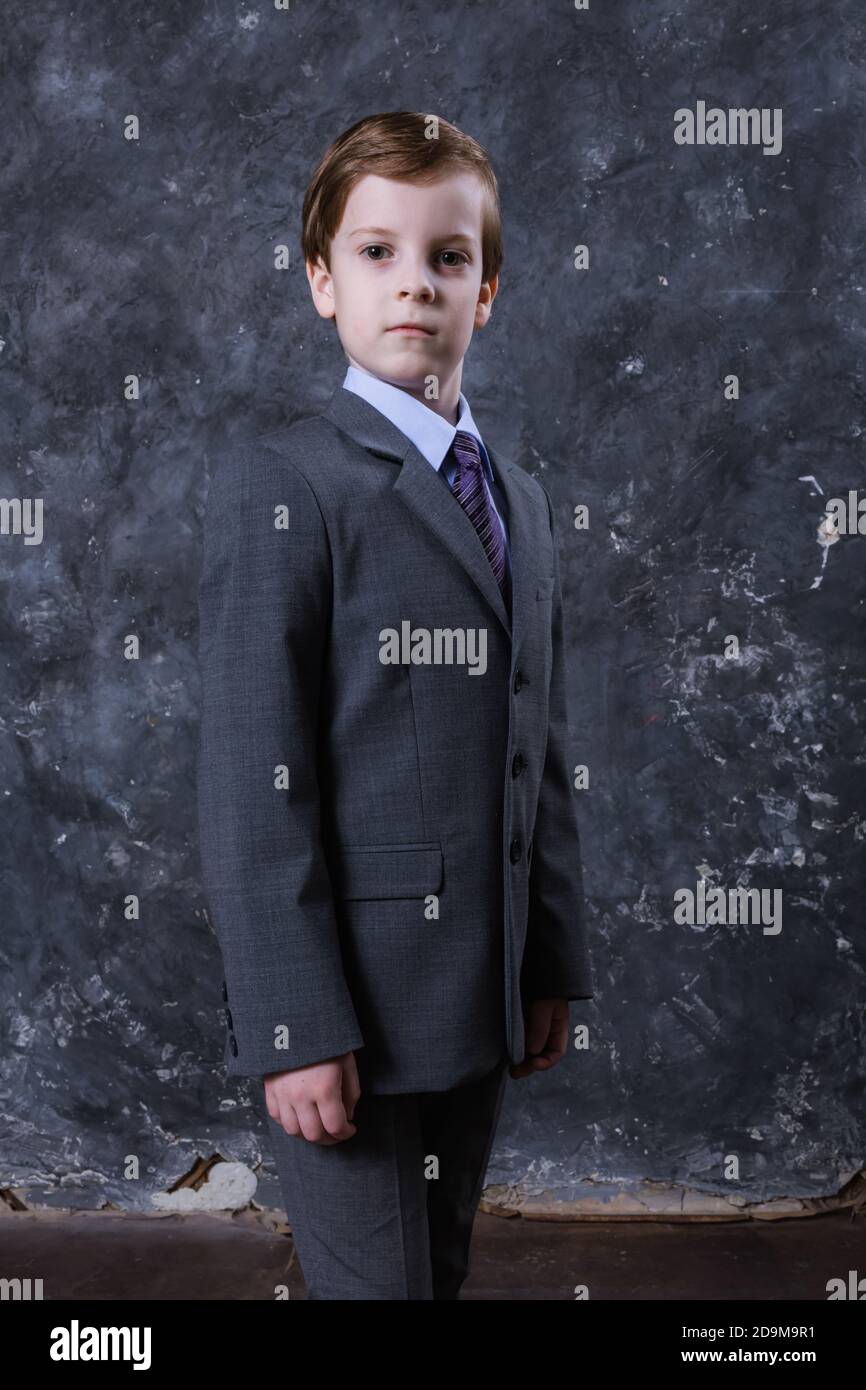 Cute schoolboy dressed in suit studio portrait Stock Photo - Alamy