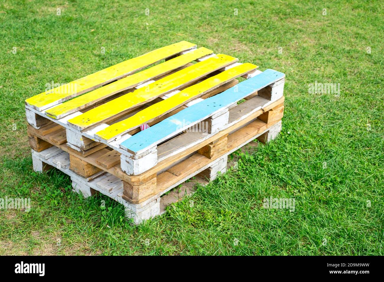colored wooden pallets on the grass Stock Photo - Alamy