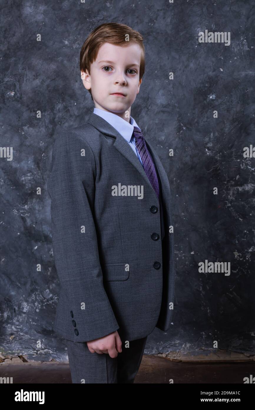 Cute schoolboy dressed in suit studio portrait Stock Photo - Alamy