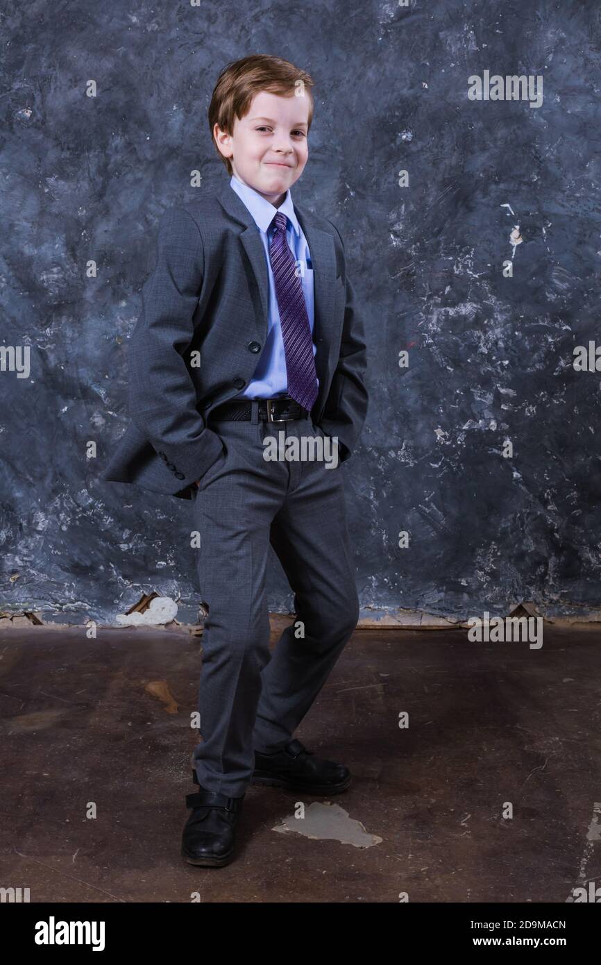 Cute schoolboy dressed in suit studio portrait Stock Photo - Alamy