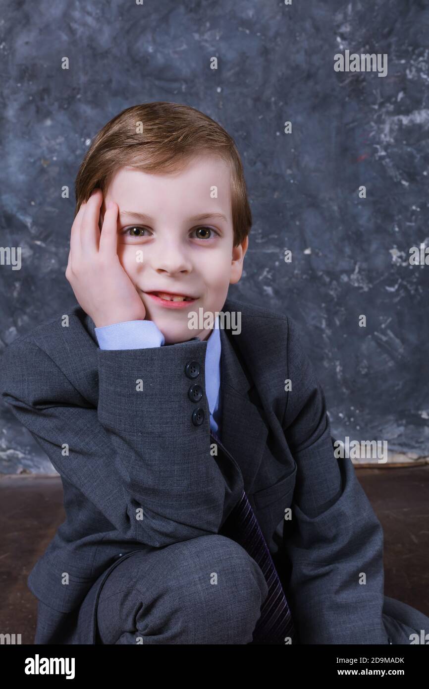 Cute schoolboy dressed in suit studio portrait Stock Photo - Alamy