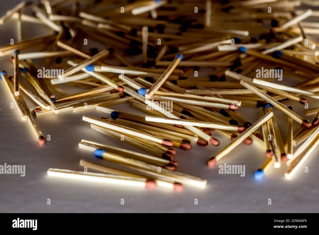 pile of blue matched sticks on dark background Stock Photo - Alamy
