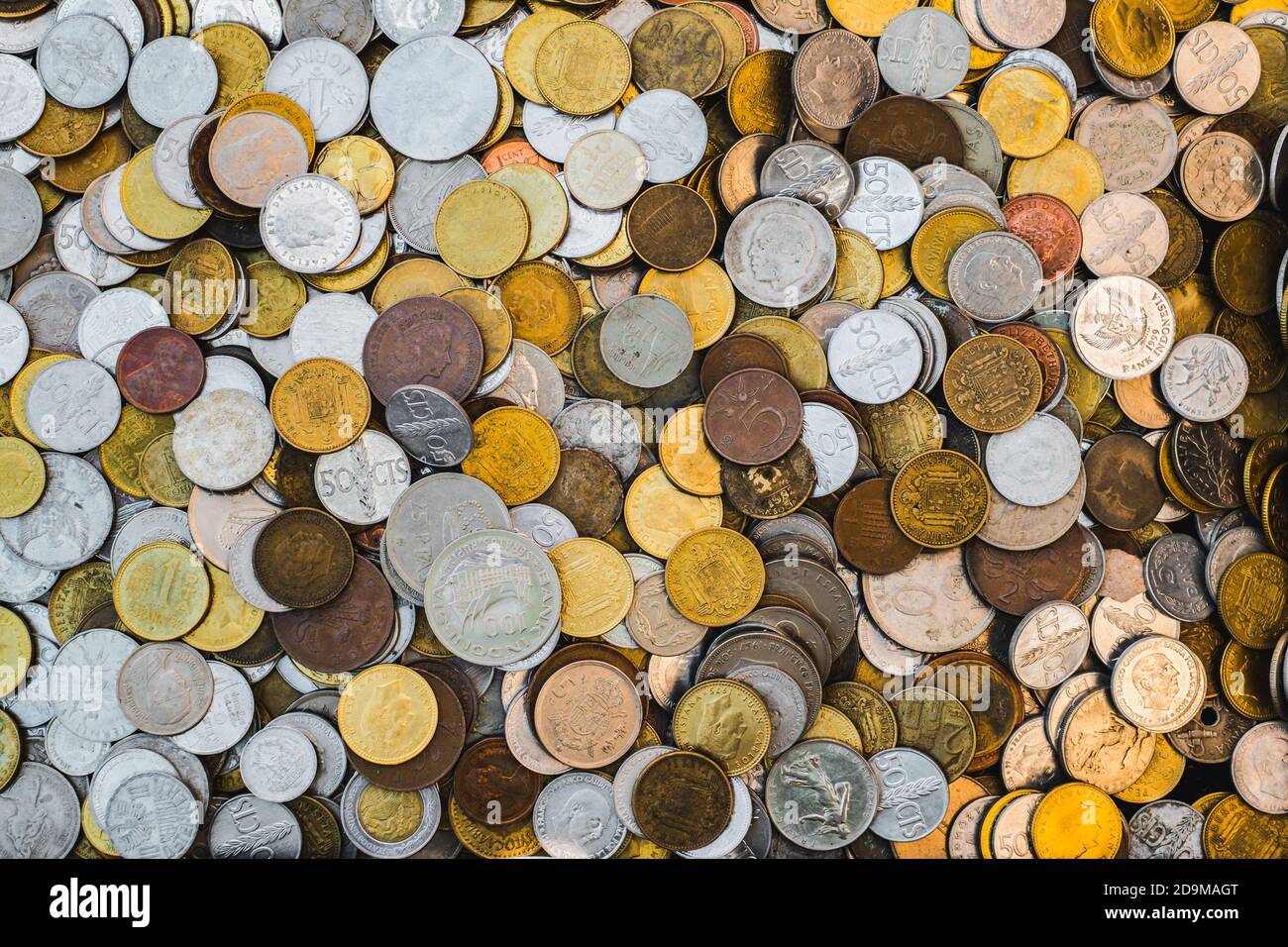 pile of coins from different countries Stock Photo - Alamy