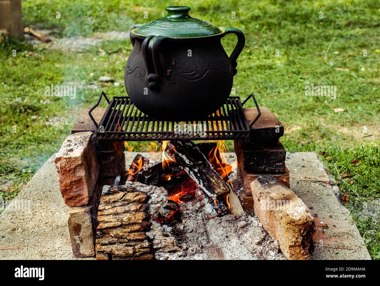 preparing Romanian traditional food in clay dishes an open fire Stock ...