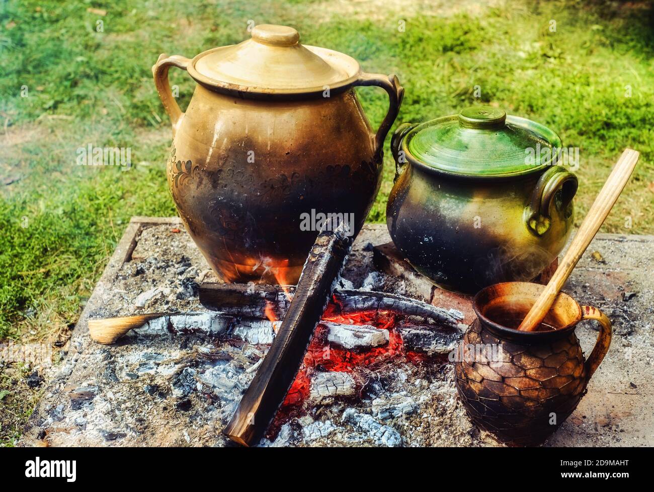 preparing Romanian traditional food in clay dishes an open fire Stock ...