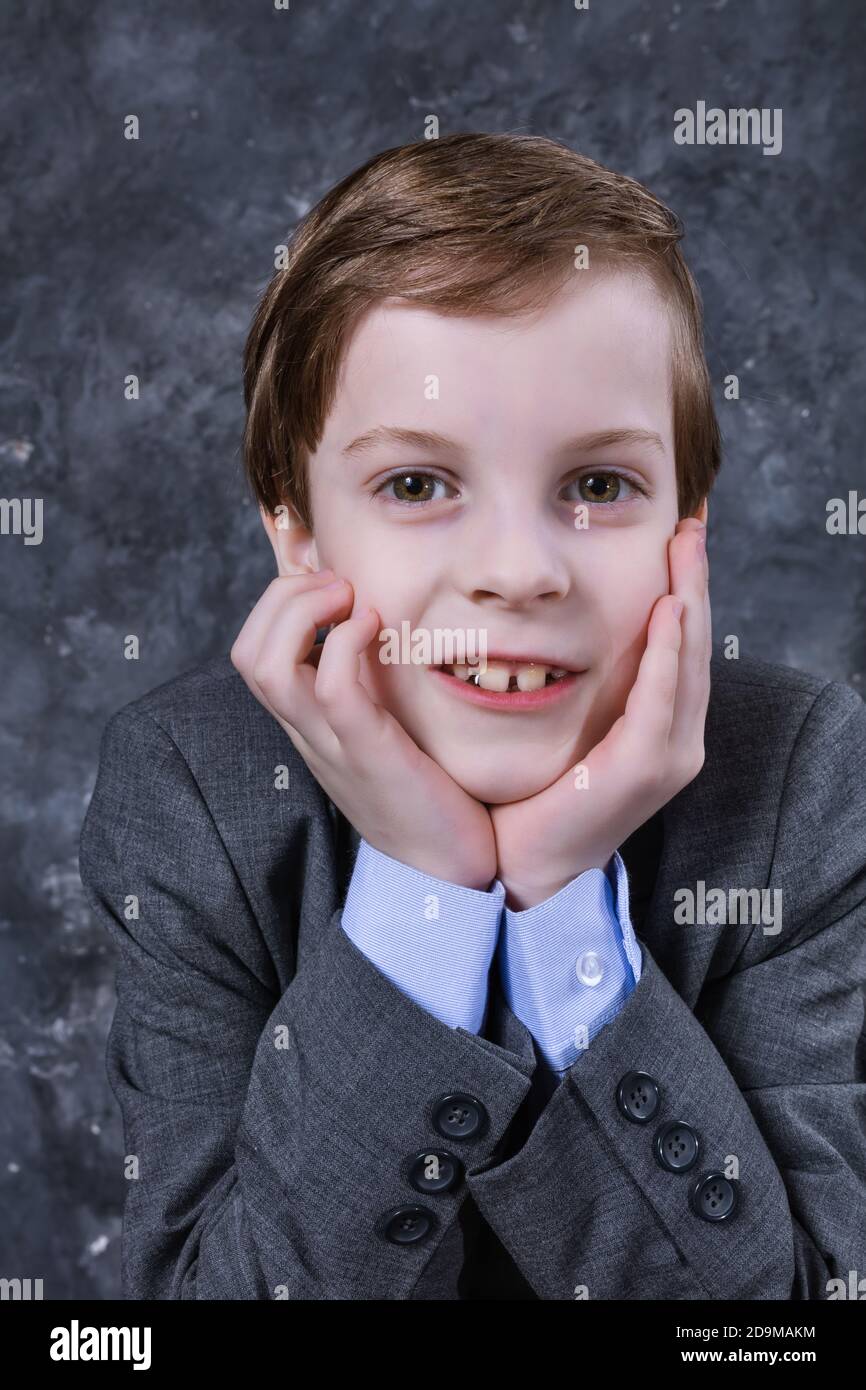 Cute schoolboy dressed in suit studio portrait Stock Photo - Alamy