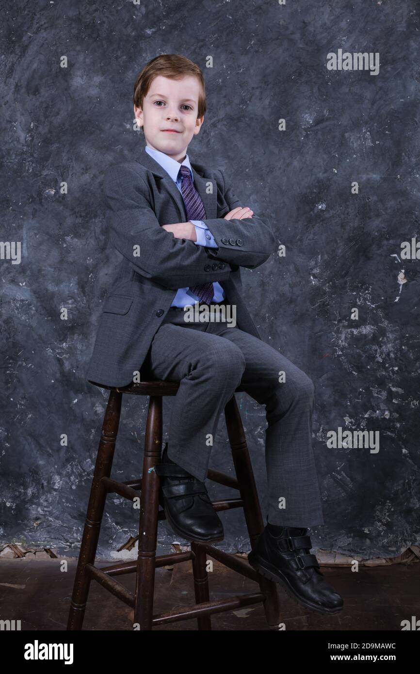 Cute schoolboy dressed in suit studio portrait Stock Photo - Alamy