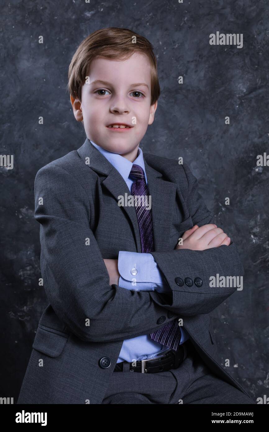 Cute schoolboy dressed in suit studio portrait Stock Photo - Alamy