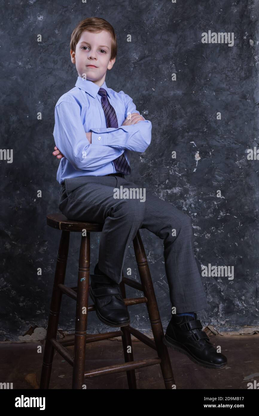 Cute schoolboy dressed in suit studio portrait Stock Photo - Alamy