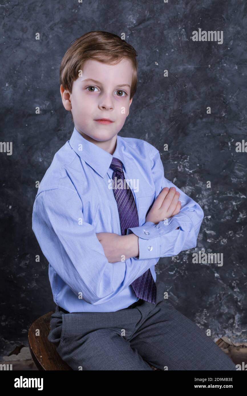 Cute schoolboy dressed in suit studio portrait Stock Photo - Alamy
