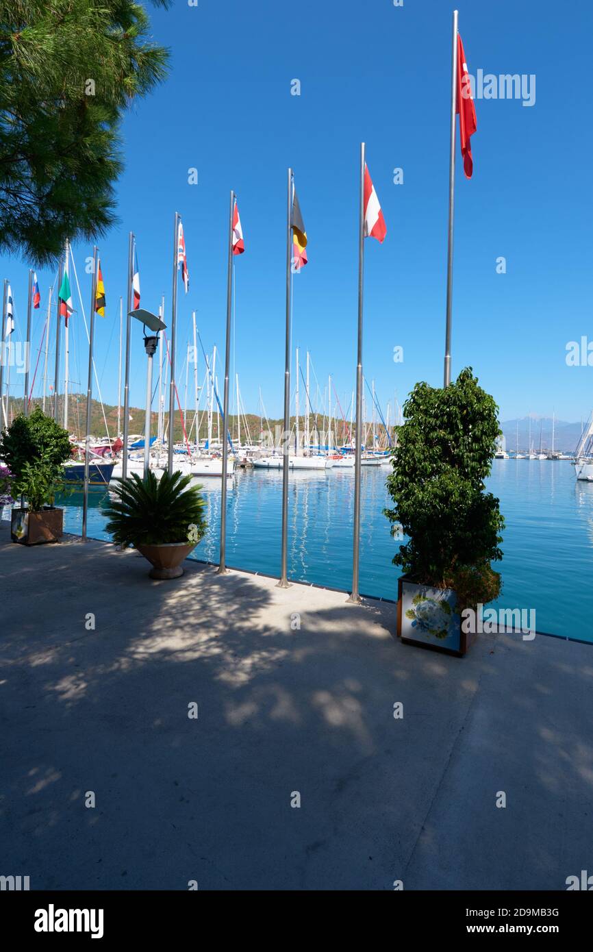 Flags and boats in Fethiye marina, Turkey Stock Photo - Alamy