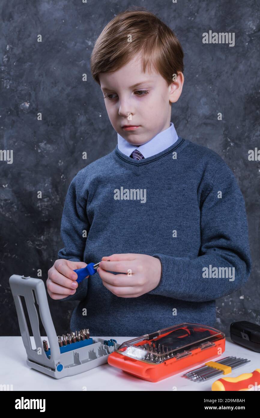 Cute boy with working tools studio portrait Stock Photo - Alamy