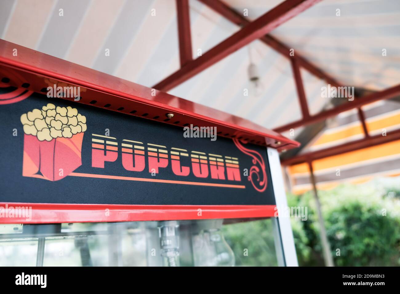 Popcorn booth signboard. Buying popped corn for a romantic evening date ...