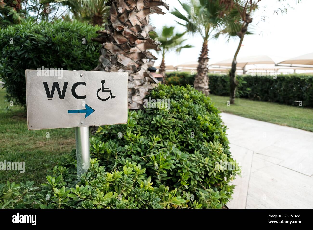 WC sign to a toilet room or washroom or bathroom or restroom including ...