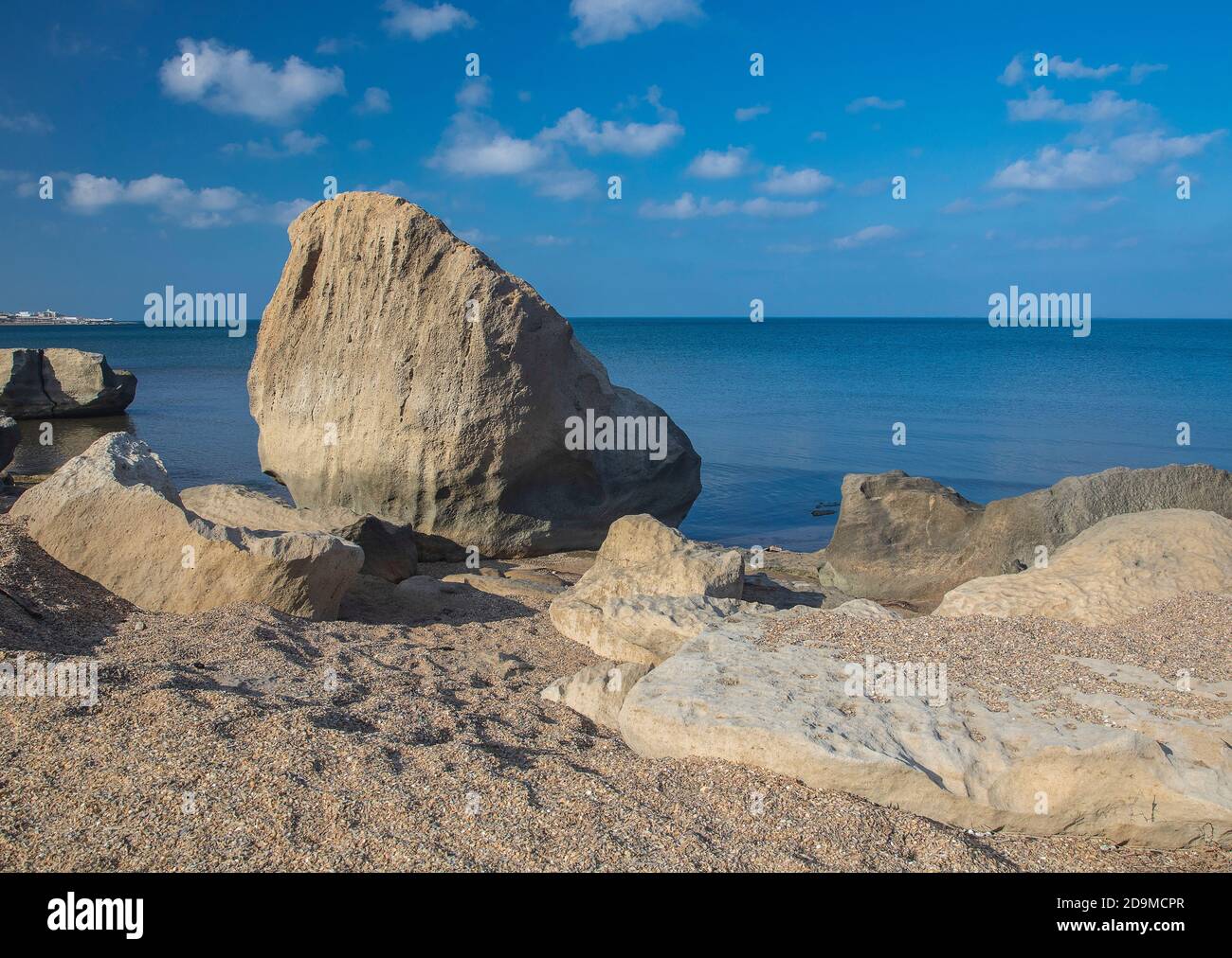 Boulders of rocks lying on the coast after the shallowing of the sea ...
