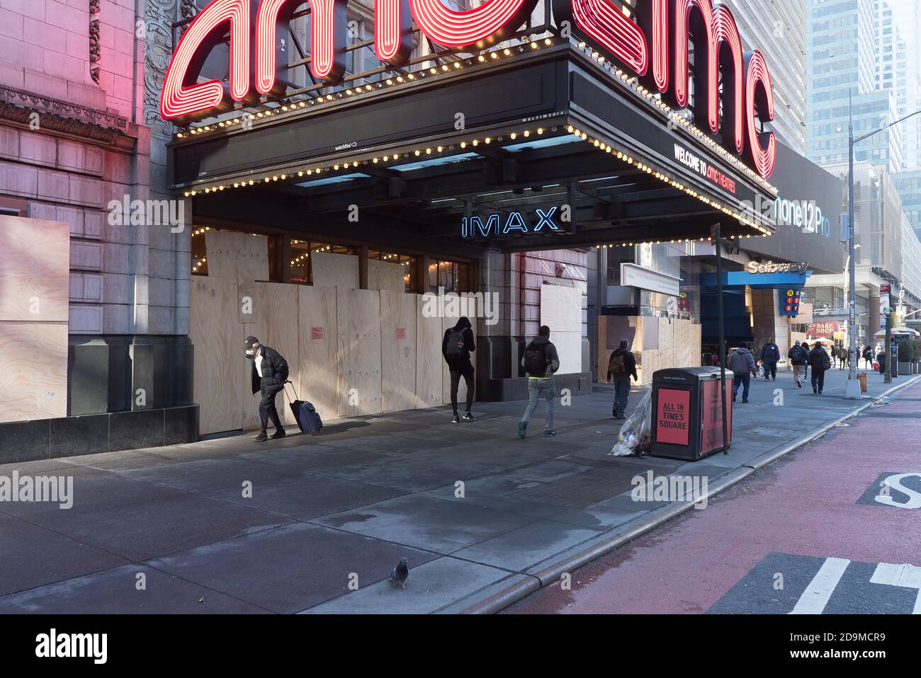 People walk by a boarded up AMC theatre on 42nd street Stock Photo - Alamy