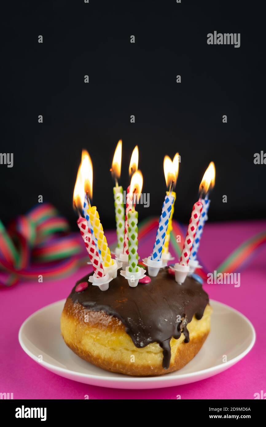 Burning birthday candles on a donut Stock Photo - Alamy