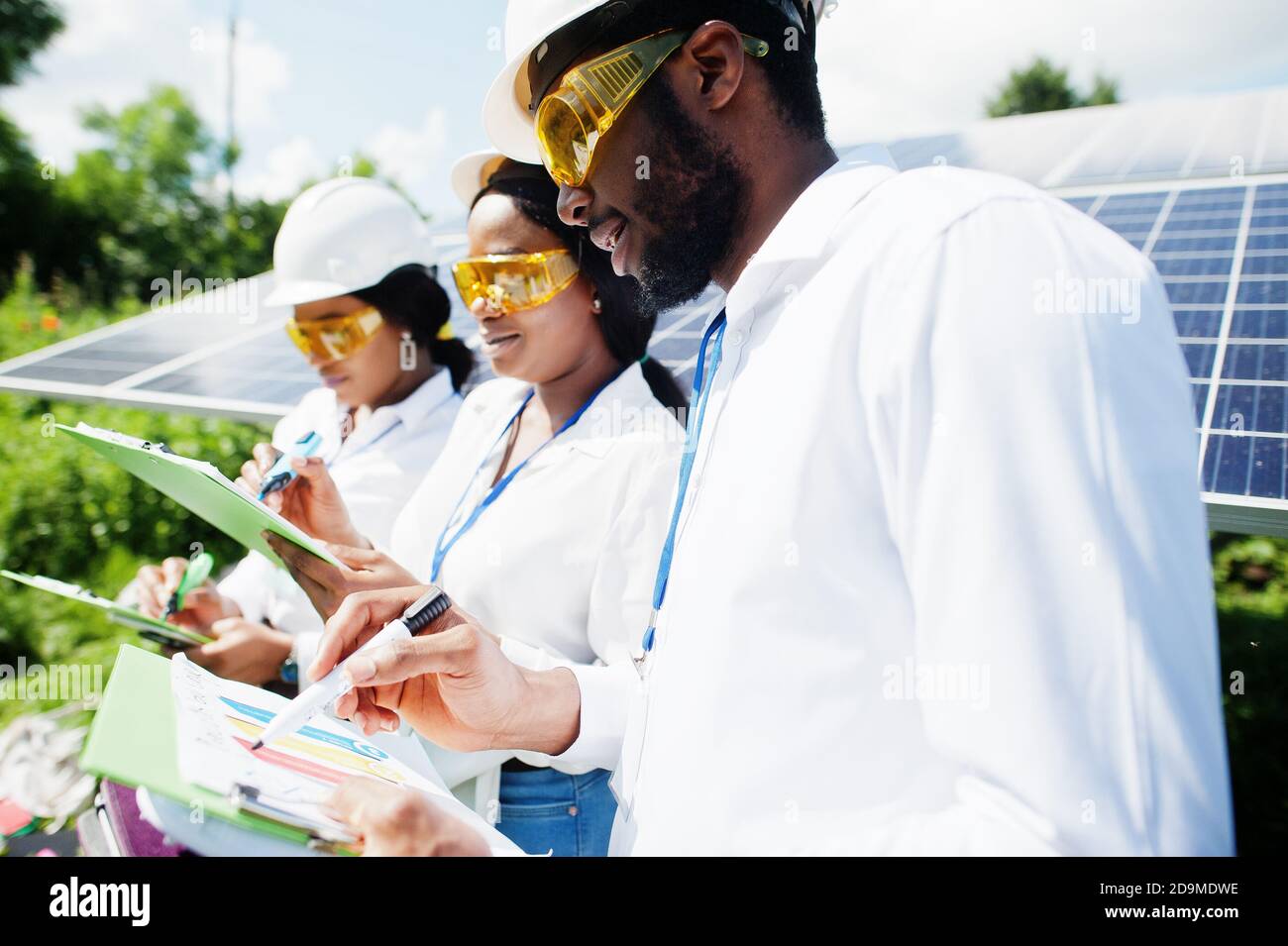 African american technician checks the maintenance of the solar panels ...