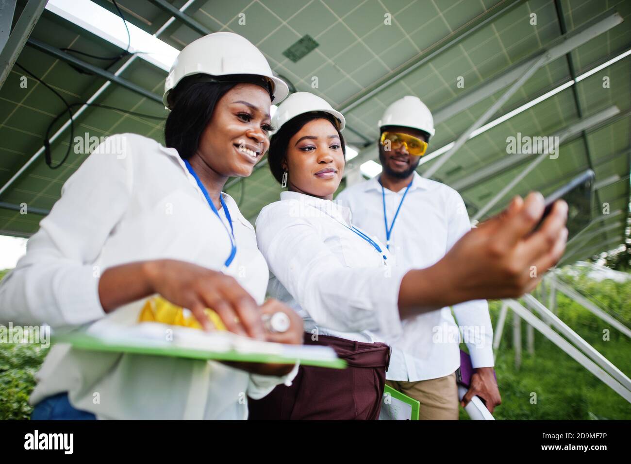 African american technician checks the maintenance of the solar panels ...