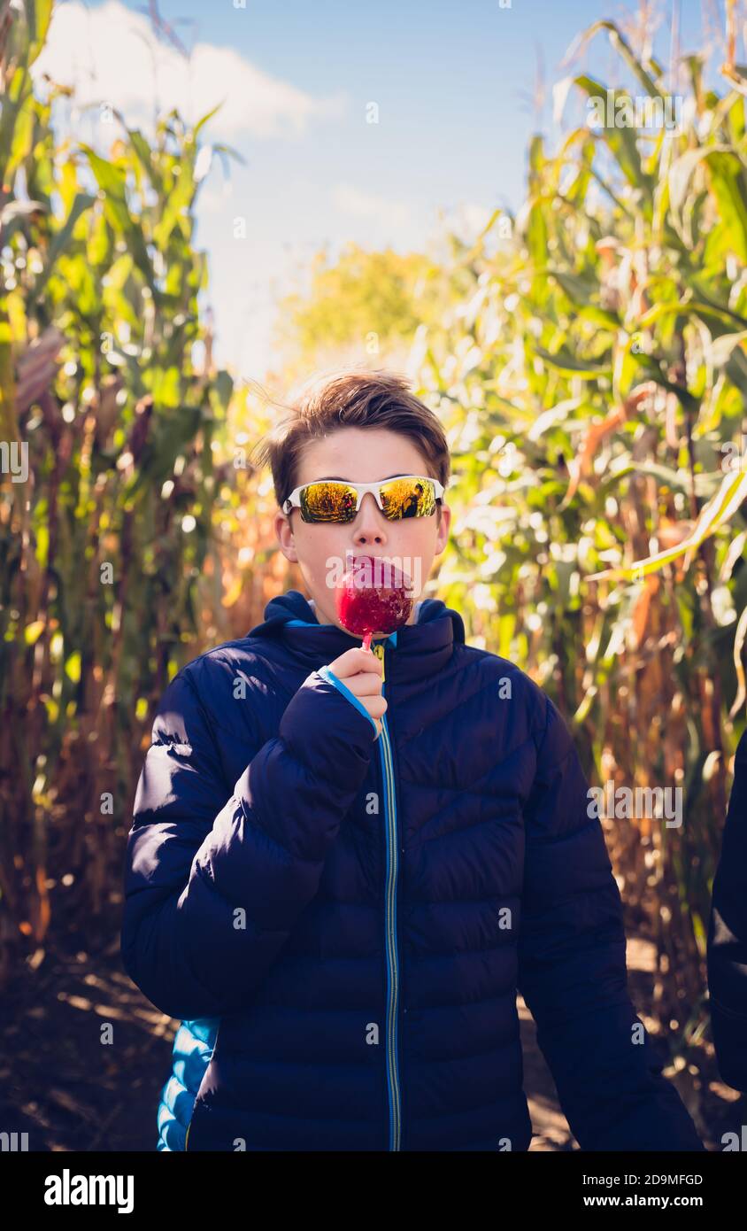 Boy eating candy apple hi-res stock photography and images - Alamy