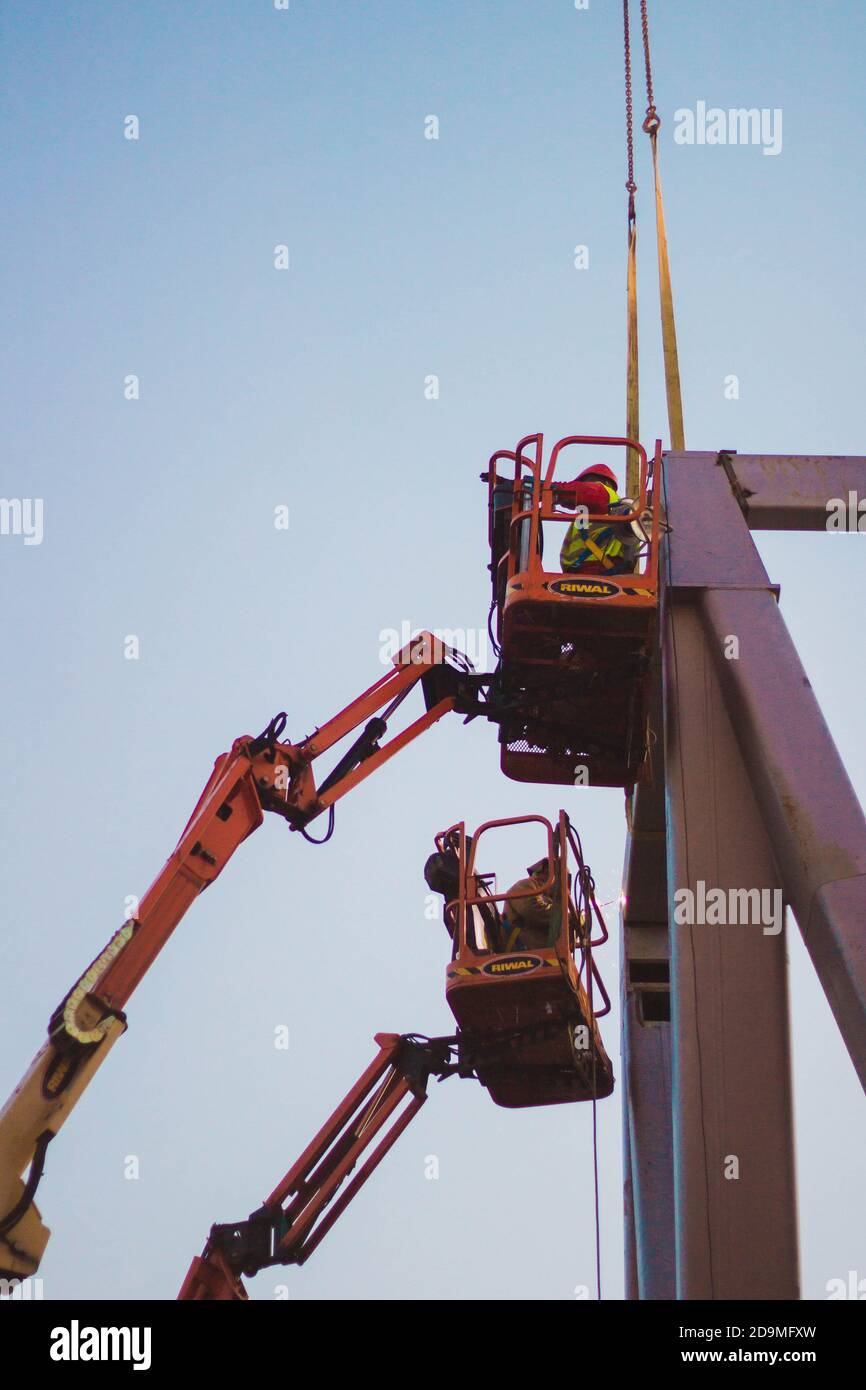 workers on a crane doing a work Stock Photo - Alamy