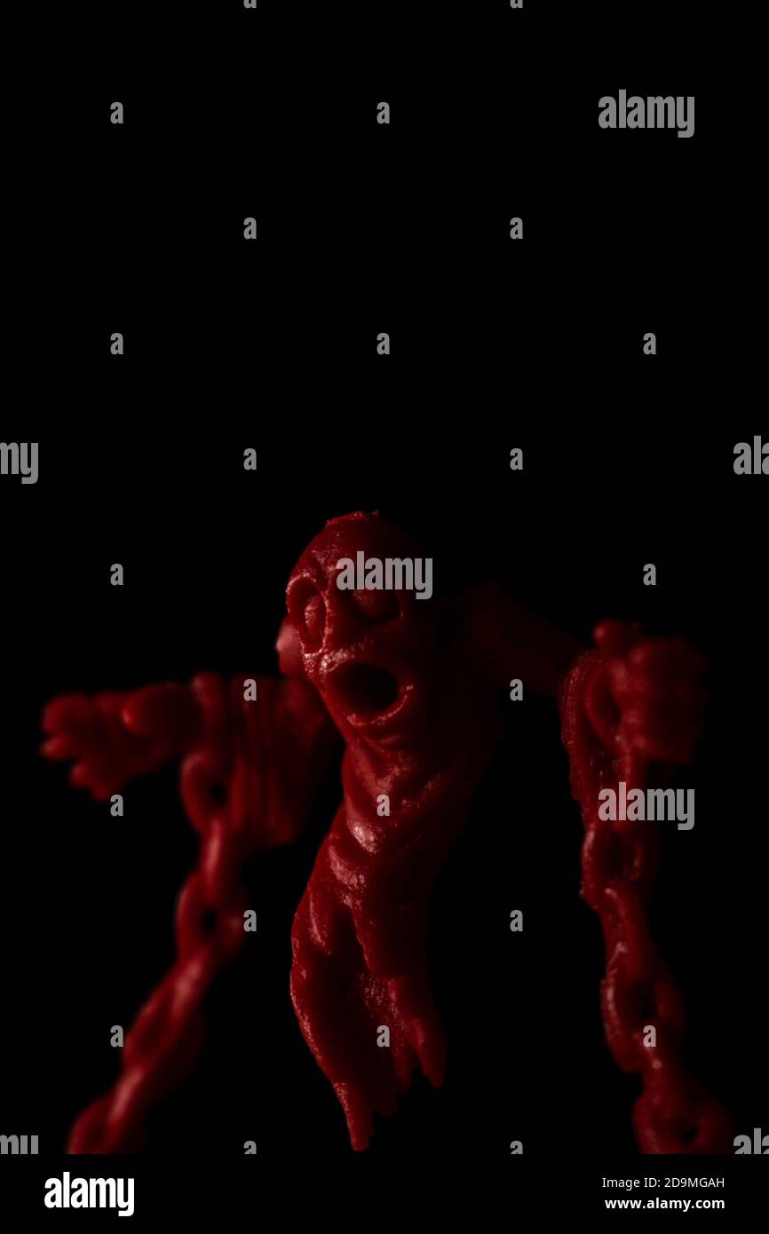 chained ghost in the darkness with a black background Stock Photo - Alamy
