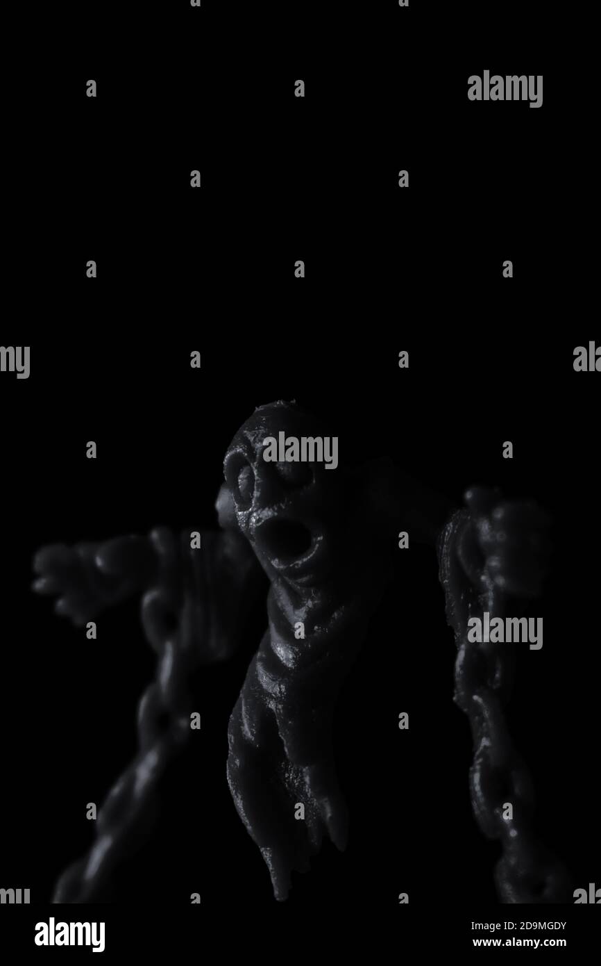 chained ghost in the darkness with a black background Stock Photo - Alamy