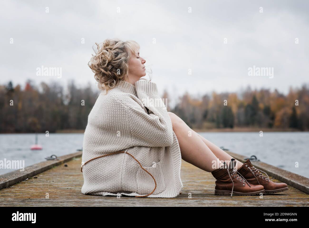 woman sat outside breathing in the fresh air looking thoughtful Stock ...