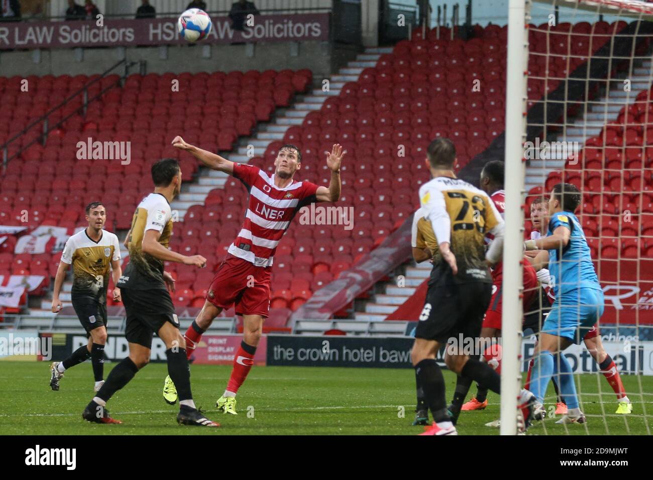 Joe Wright (5) of Doncaster Rovers jumps to win the high ball Stock ...