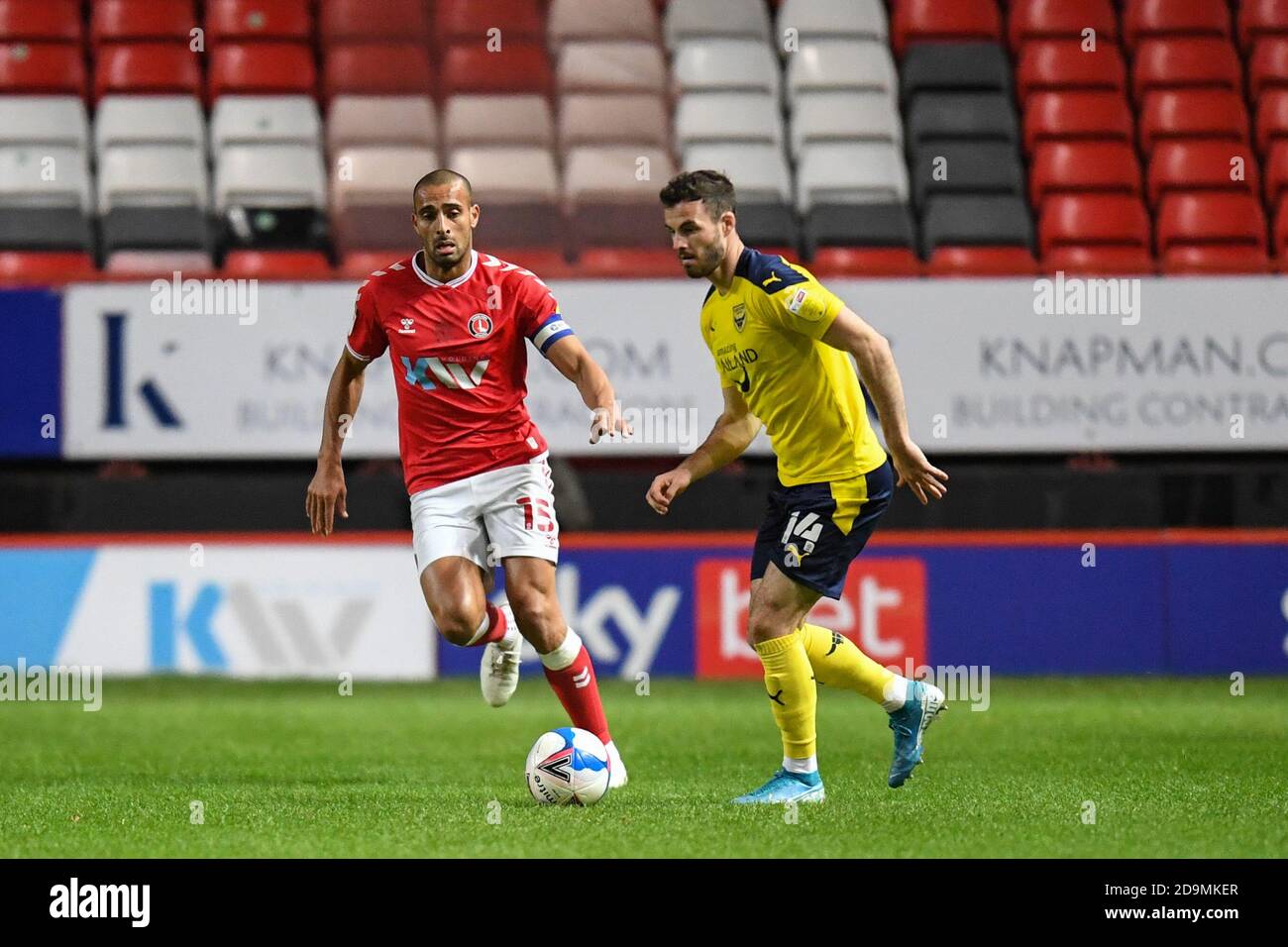 Anthony Forde (14) of Oxford United runs with the ball tracked by ...