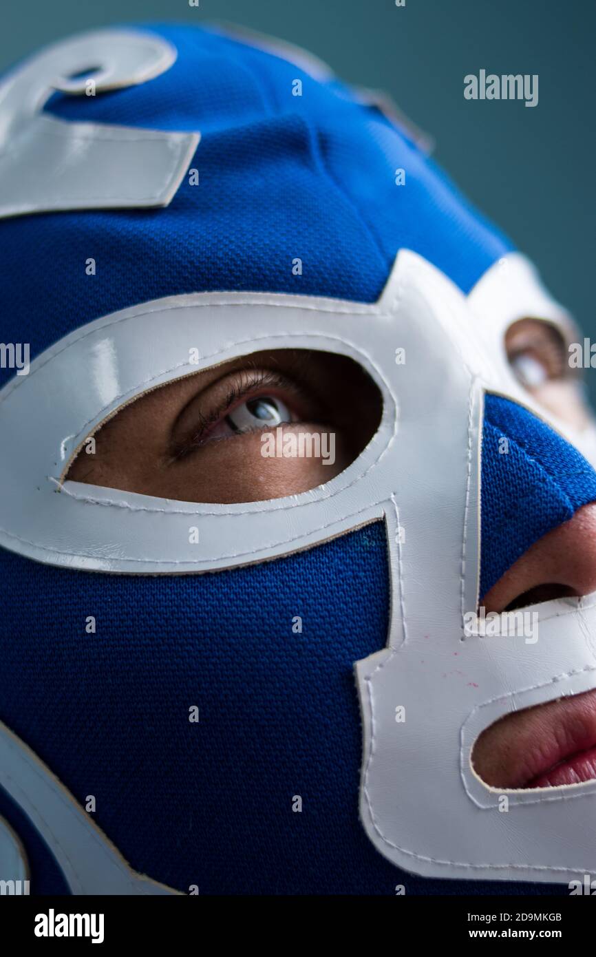 Close up of blue eyed man wearing a blue wrestling mask Stock Photo - Alamy