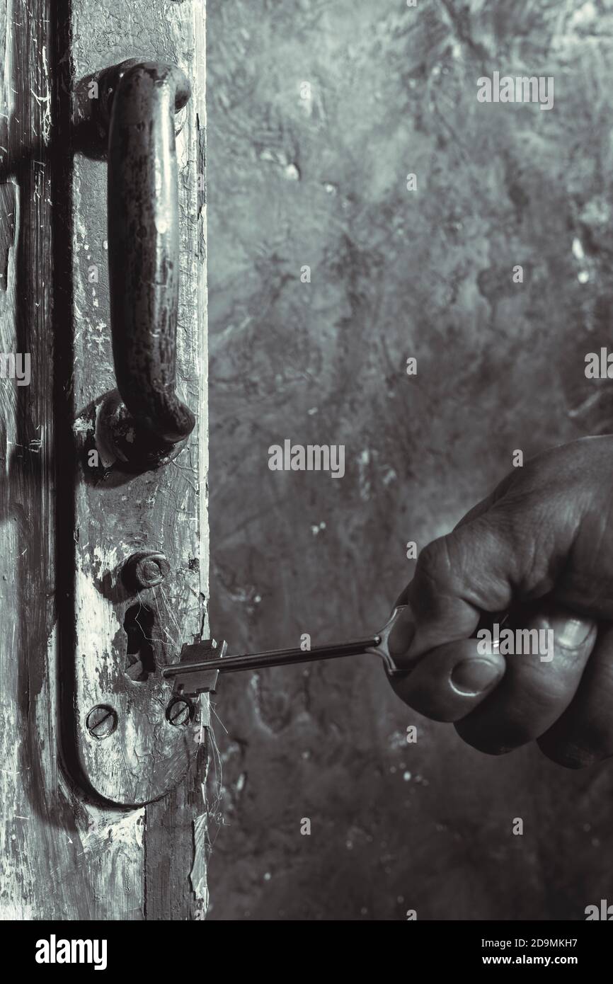 Hand with vintage key and keyhole close up view studio shot Stock Photo ...